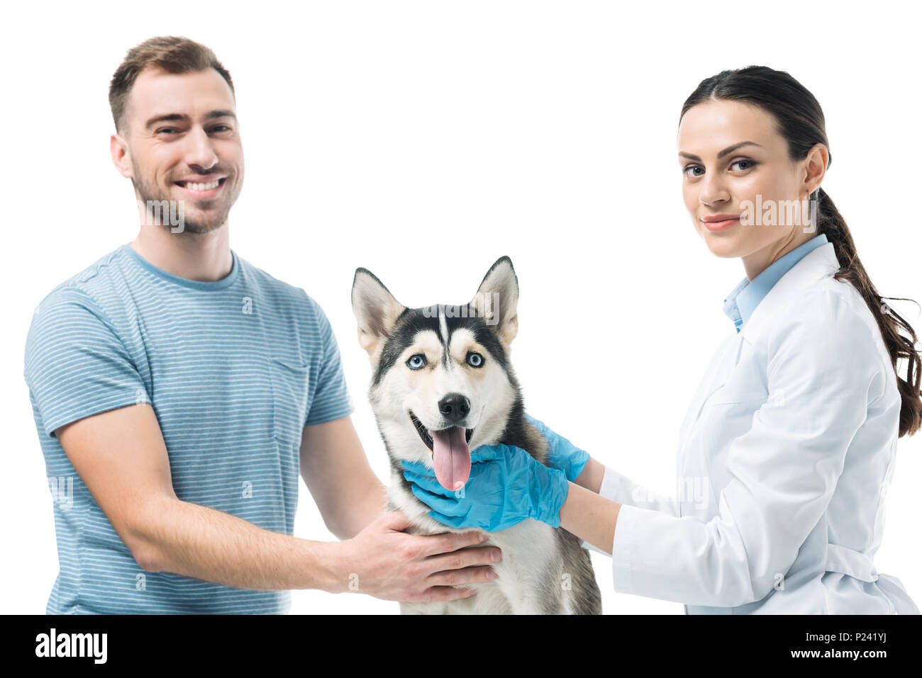 smiling young man with husky and female veterinarian isolated on white ...