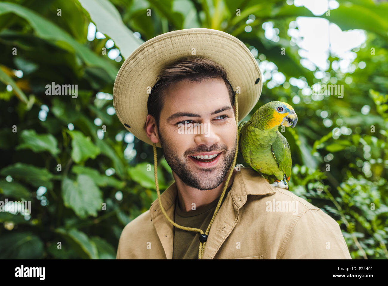 handsome young man with parrot on shoulder Stock Photo - Alamy