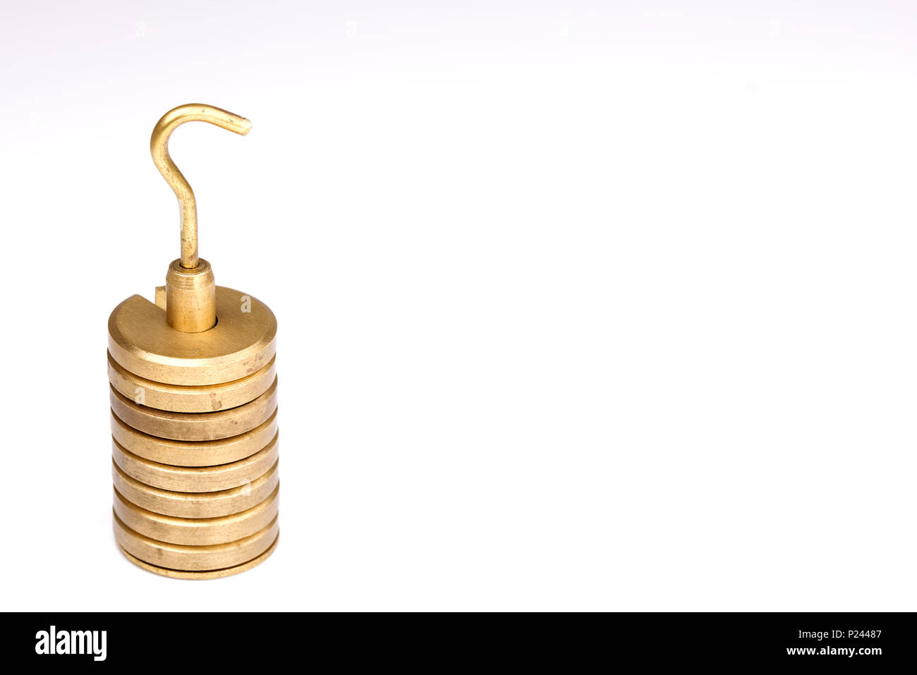 Brass gold colour 10 gram slotted masses weights isolated on a white ...