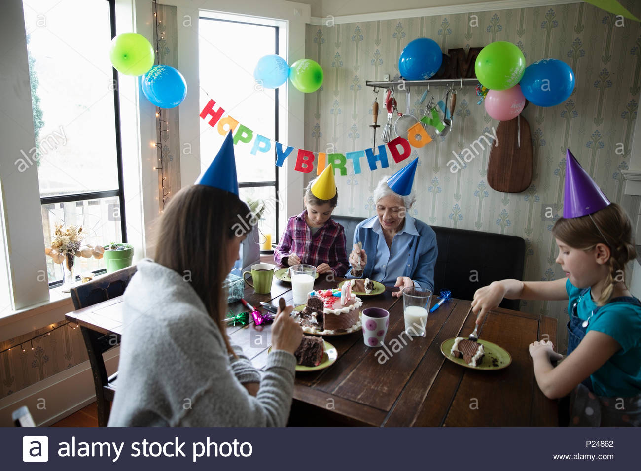 Multi-generation women celebrating birthday, enjoying cake Stock Photo ...