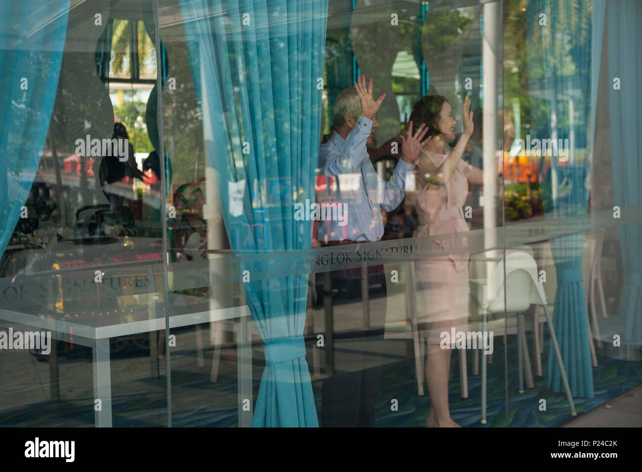 Singapore, Singapore, people waving out of the window Stock Photo - Alamy