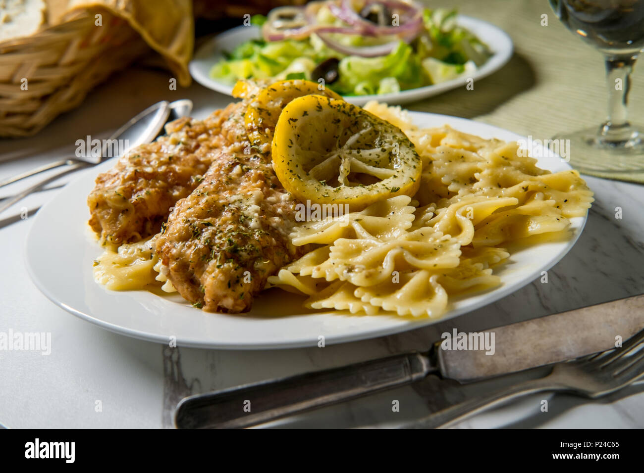 Italian American Chicken francese with farfalle pasta and side salad ...