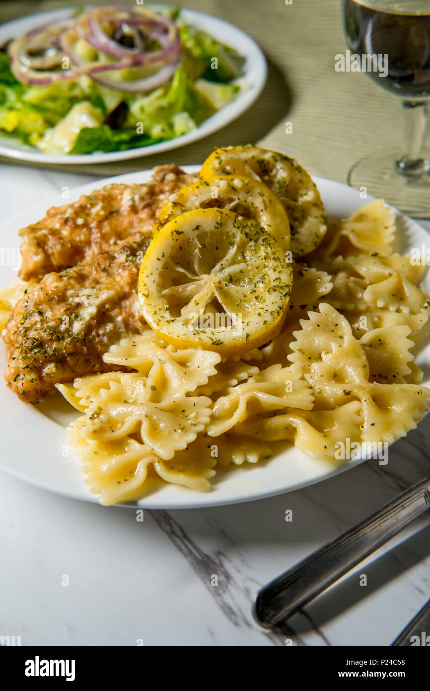 Italian American Chicken francese with farfalle pasta and side salad ...