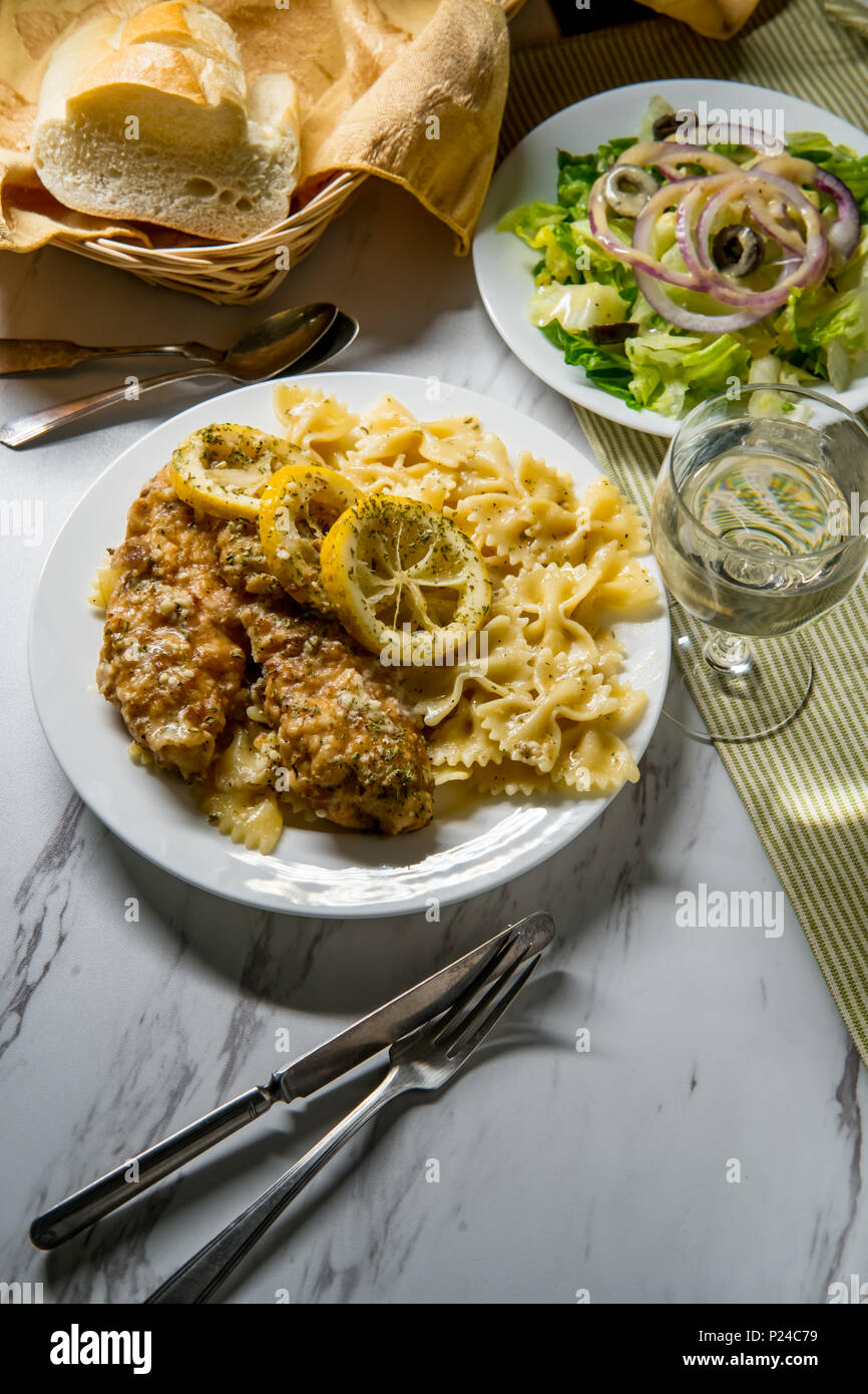 Italian American Chicken francese with farfalle pasta and side salad ...
