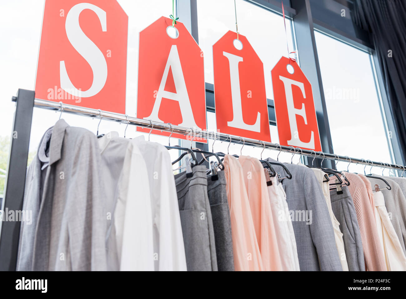 rack with hanging clothes in store Stock Photo - Alamy