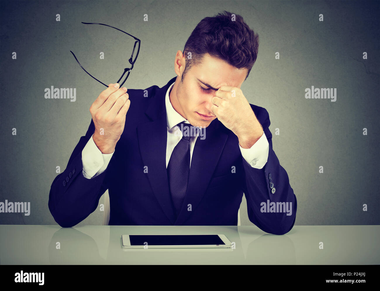 Frustrated young handsome man looking exhausted feeling tired sitting ...