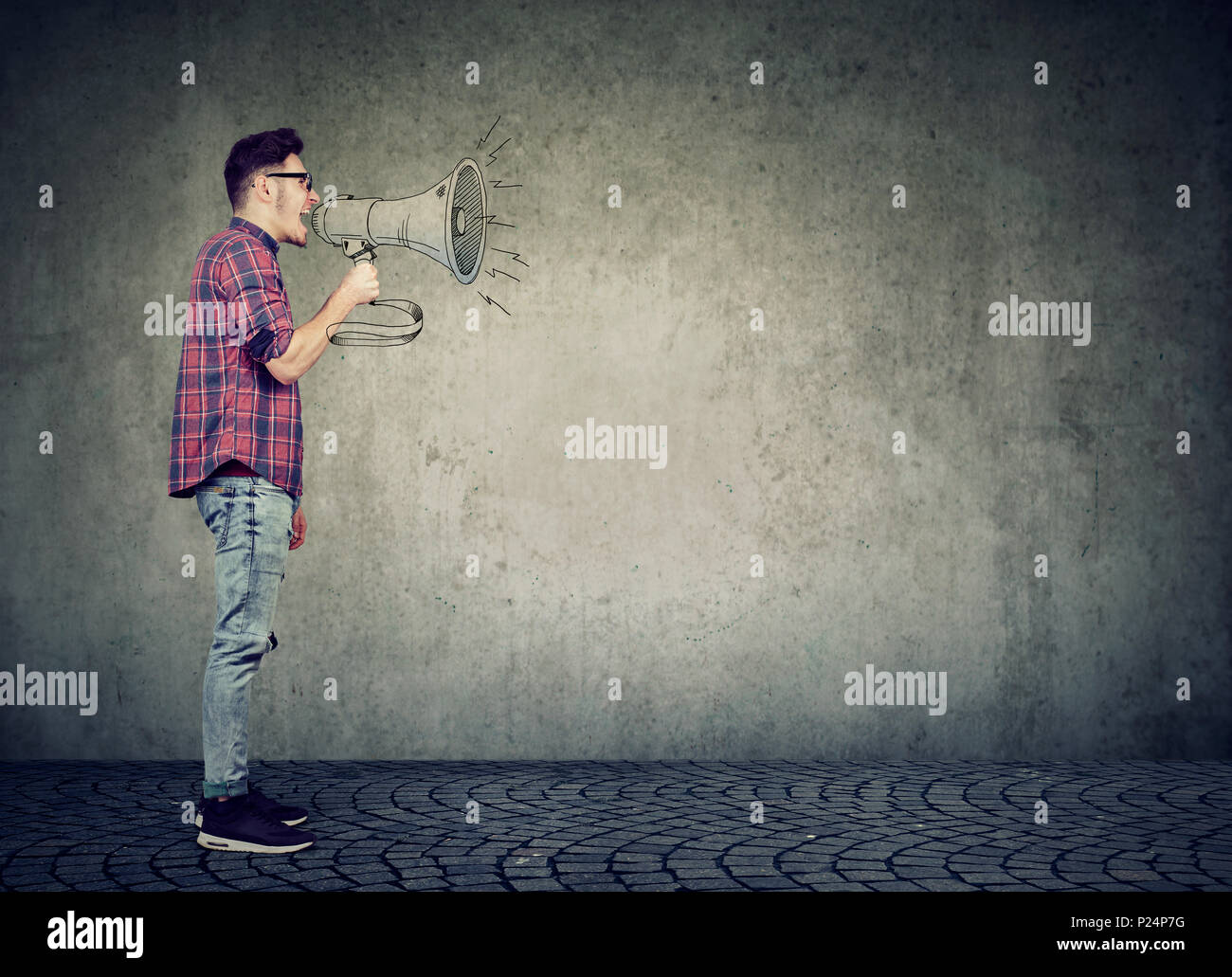 Side view of casual man speaking with loudspeaker giving speech and ...