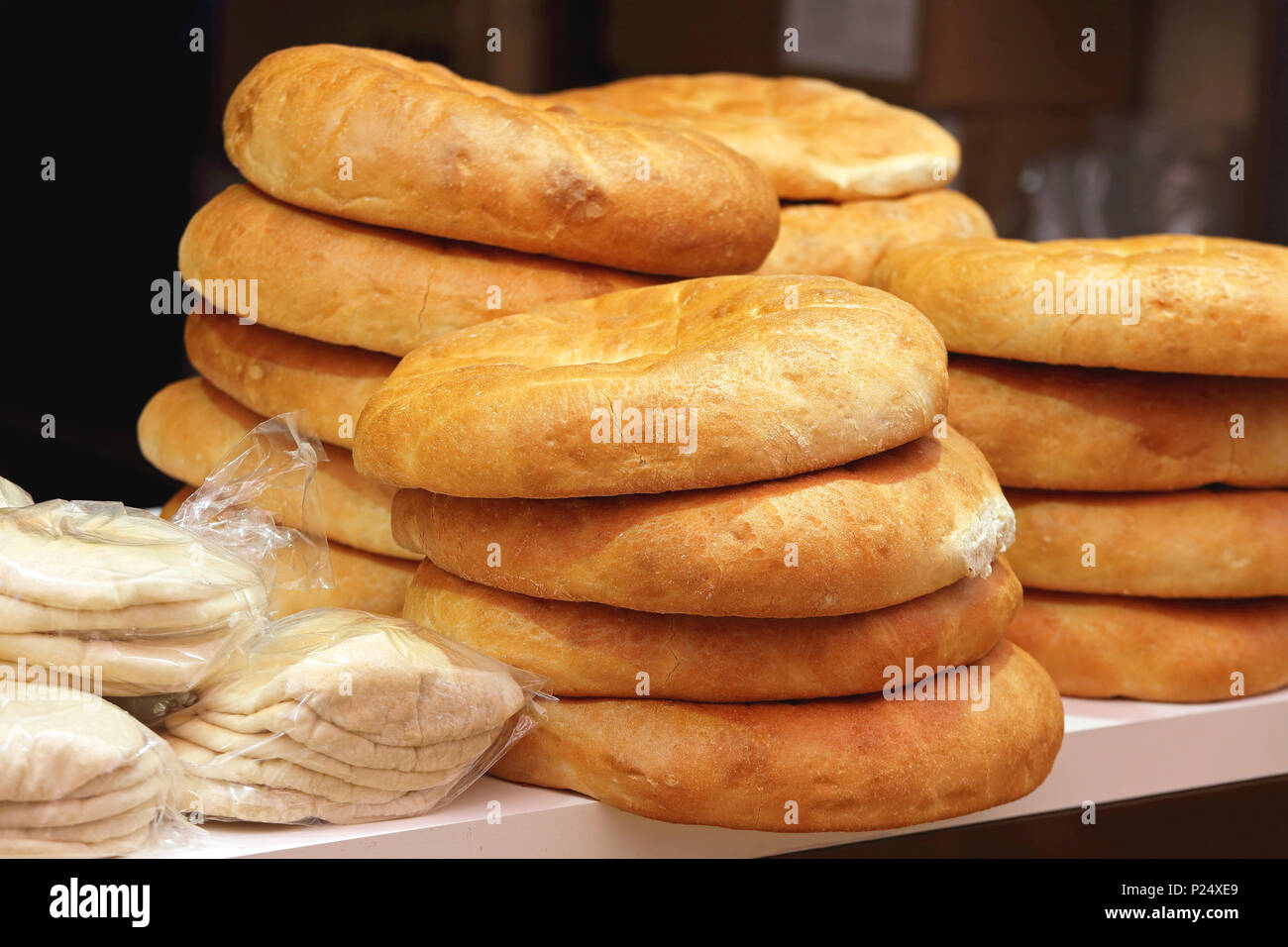 Stacked Loaves of White Bread in Bakery Stock Photo - Alamy
