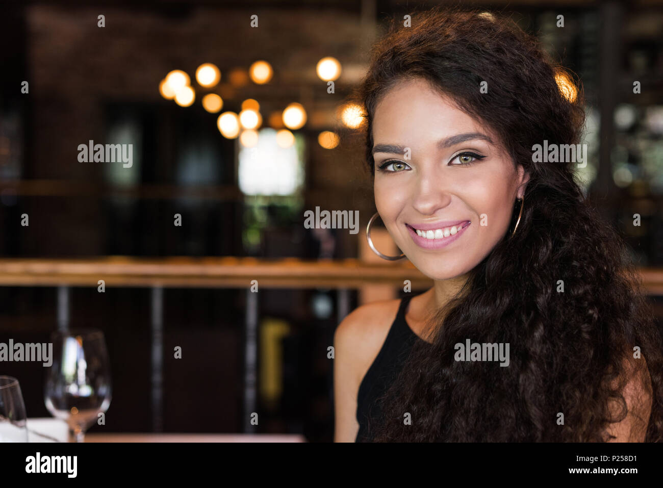 Woman sitting in restaurant hi-res stock photography and images - Alamy