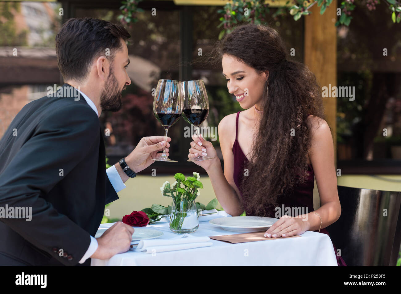 Couple having romantic date, sitting at table in restaurant and ...