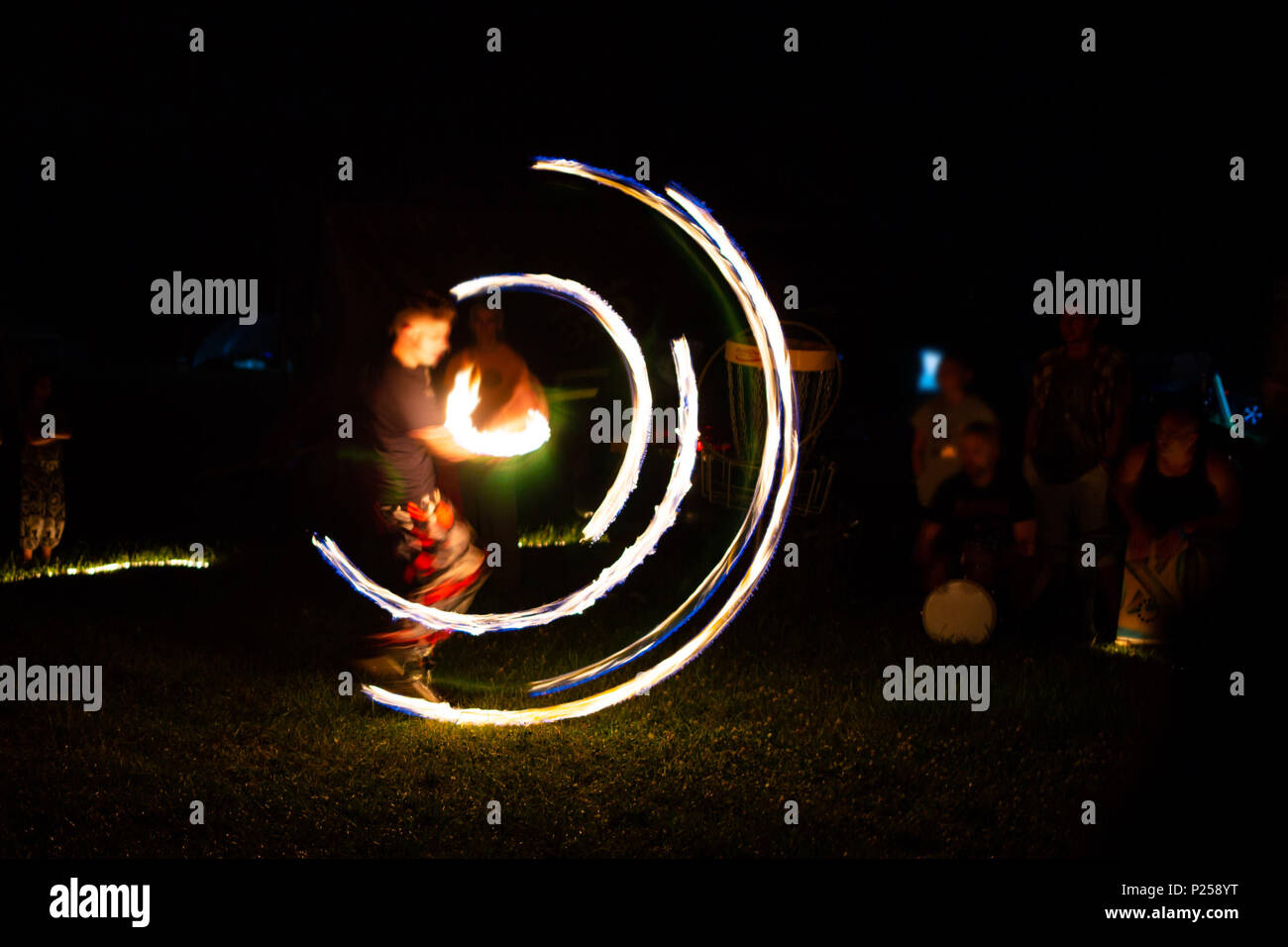 Beautiful solo fire show performance at night Stock Photo - Alamy