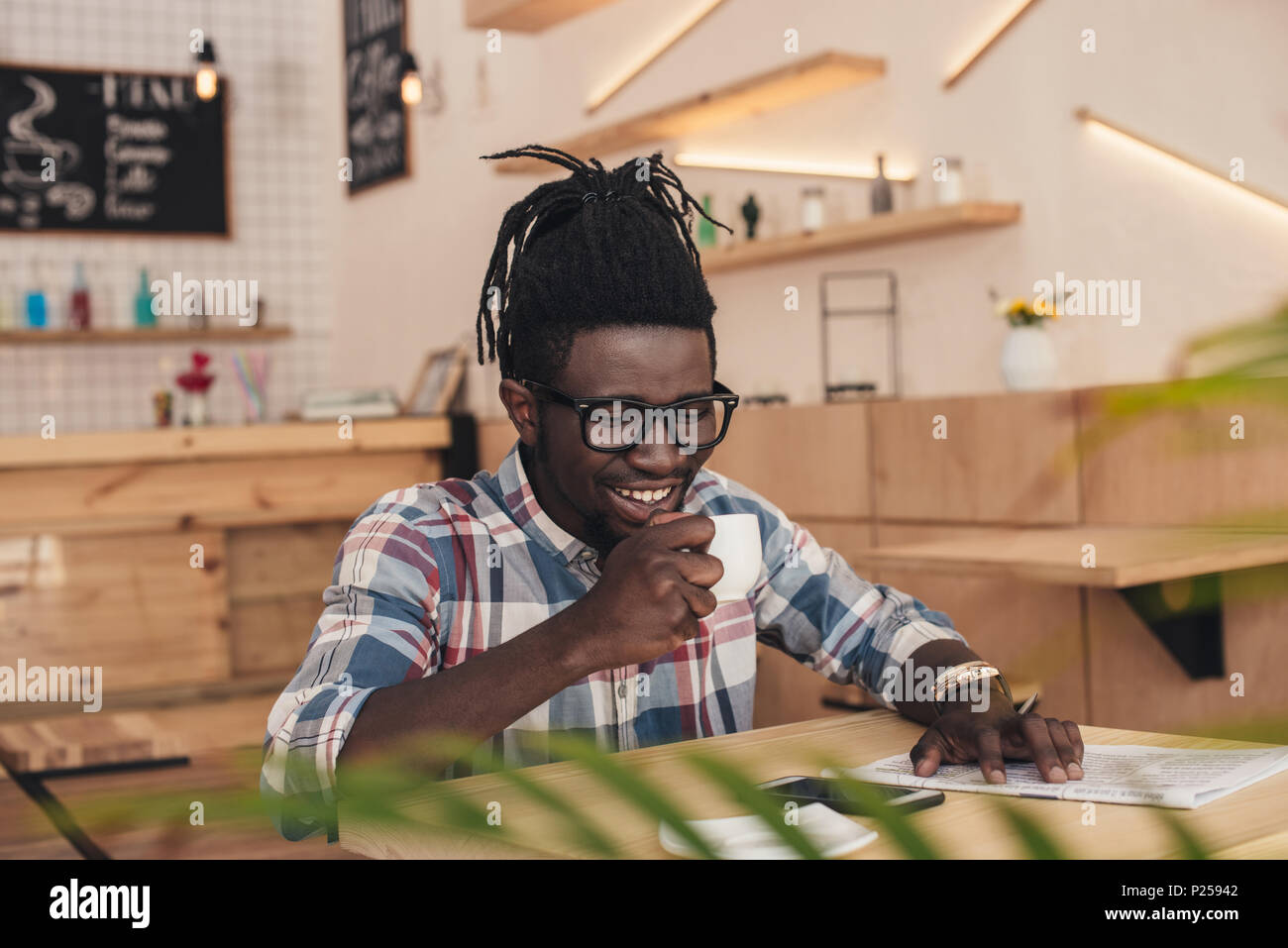 cheerful african american man drinking aromatic coffee in cafe Stock ...