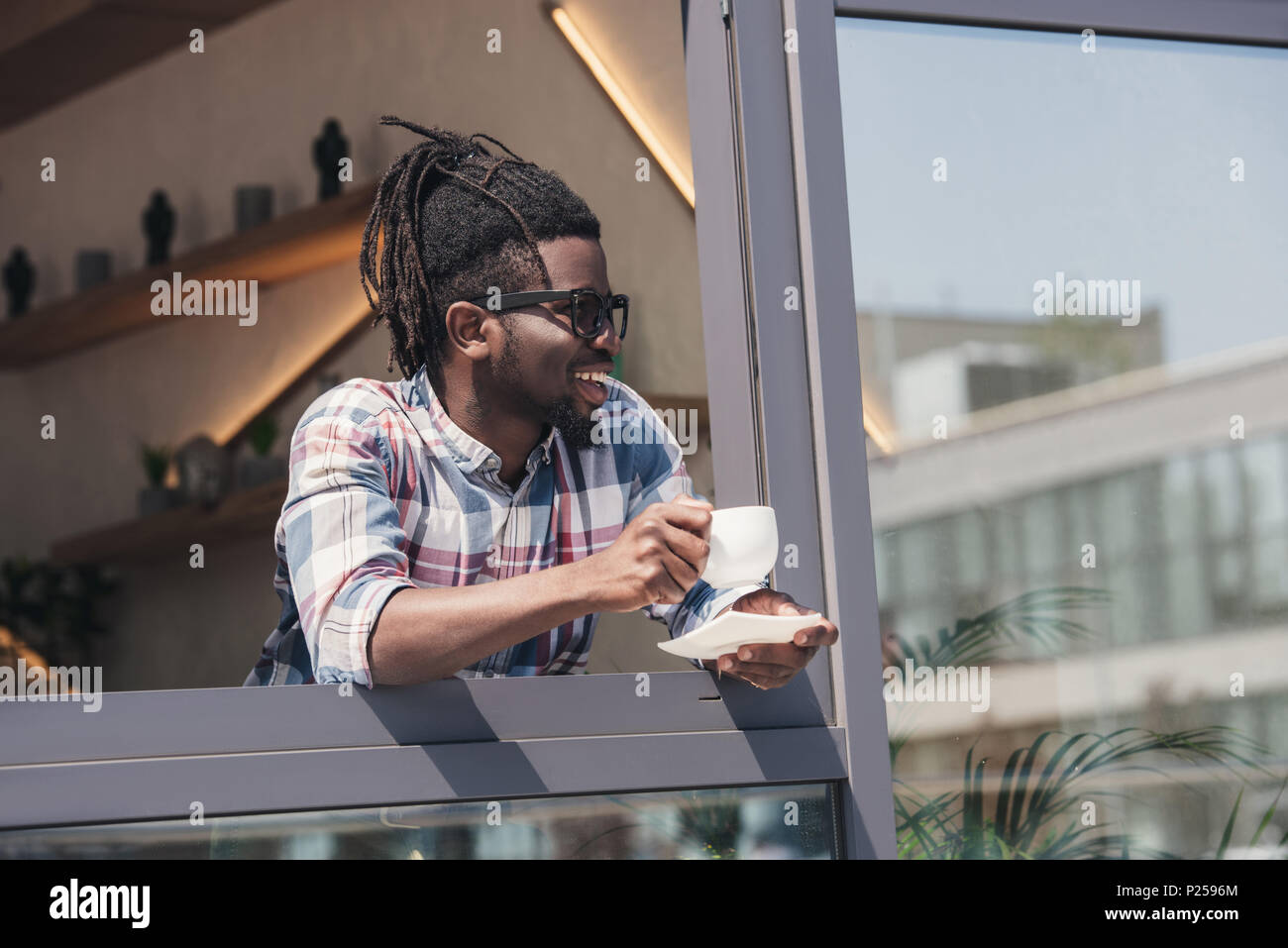 cheerful african american man drinking coffee in cafe Stock Photo - Alamy
