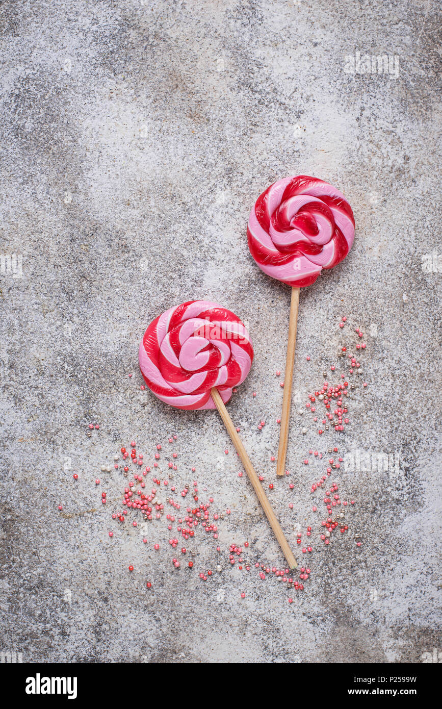 Pink lollipop on light background Stock Photo - Alamy