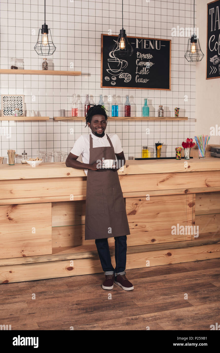 African waiter pouring coffee hi-res stock photography and images - Alamy