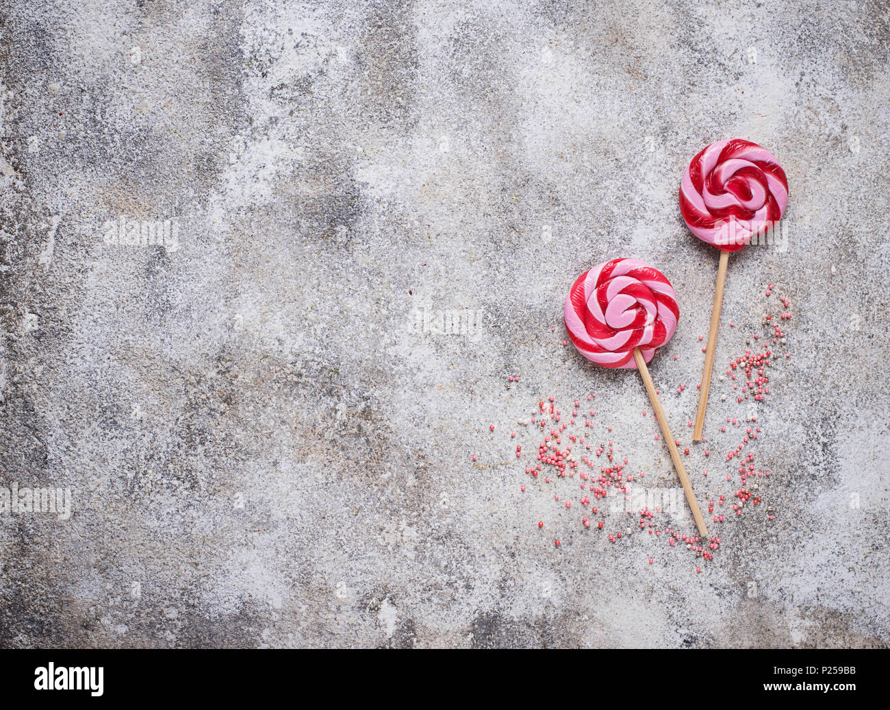 Pink lollipop on light background Stock Photo - Alamy