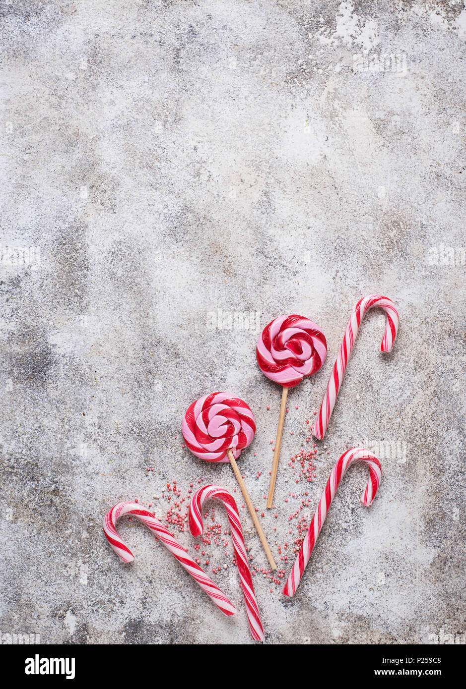 Pink lollipop and candy cane Stock Photo - Alamy