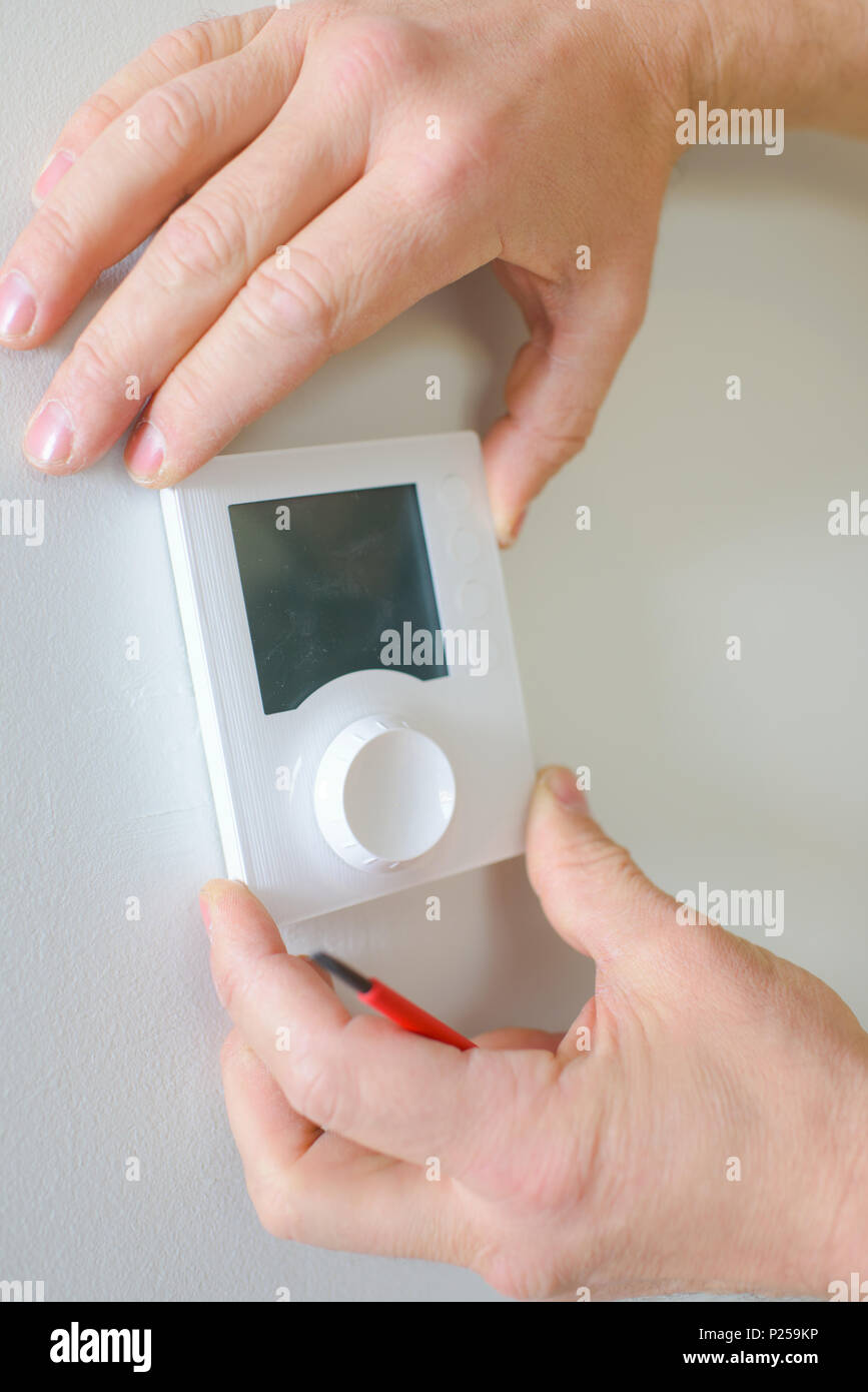 Electronic control pad being fitted to wall Stock Photo - Alamy