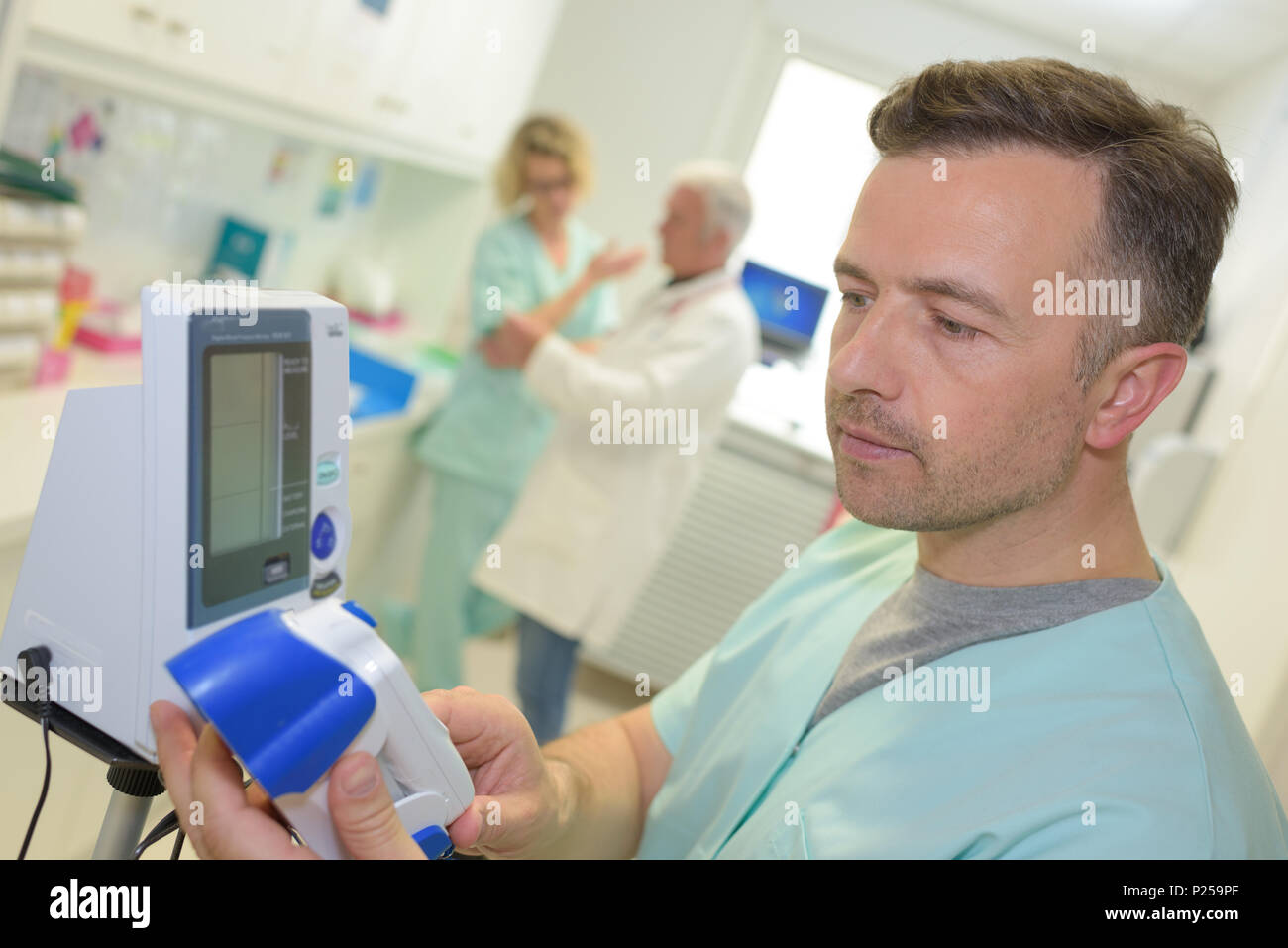 Medical worker setting up machine Stock Photo - Alamy