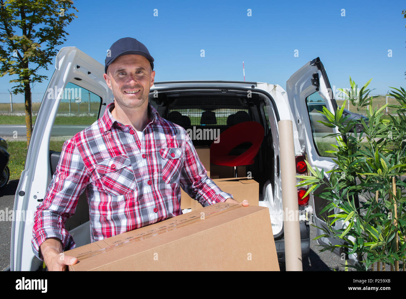 delivery man with cardboard box Stock Photo - Alamy