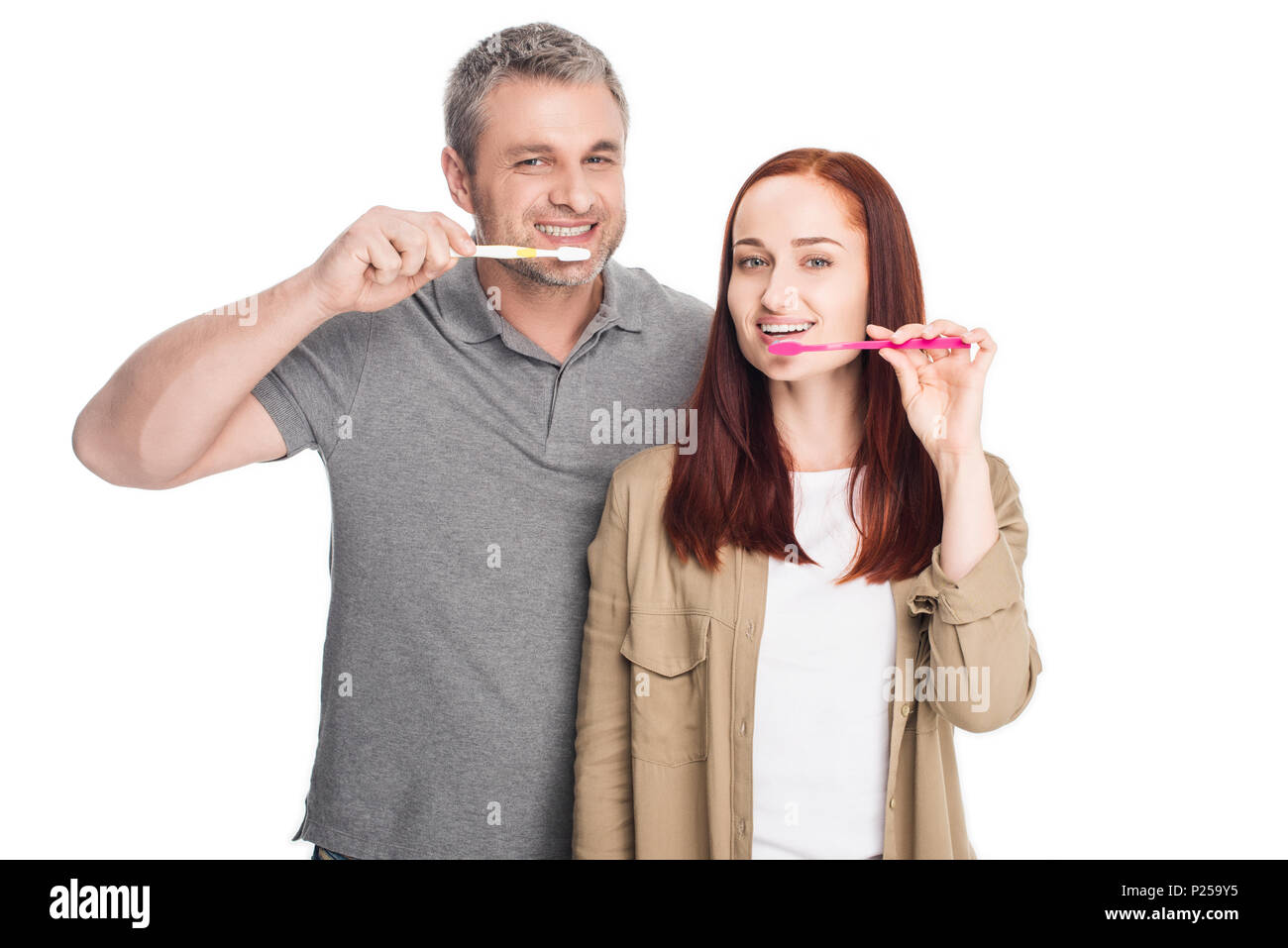 young couple brushing teeth with tooth brushes, isolated on white Stock ...