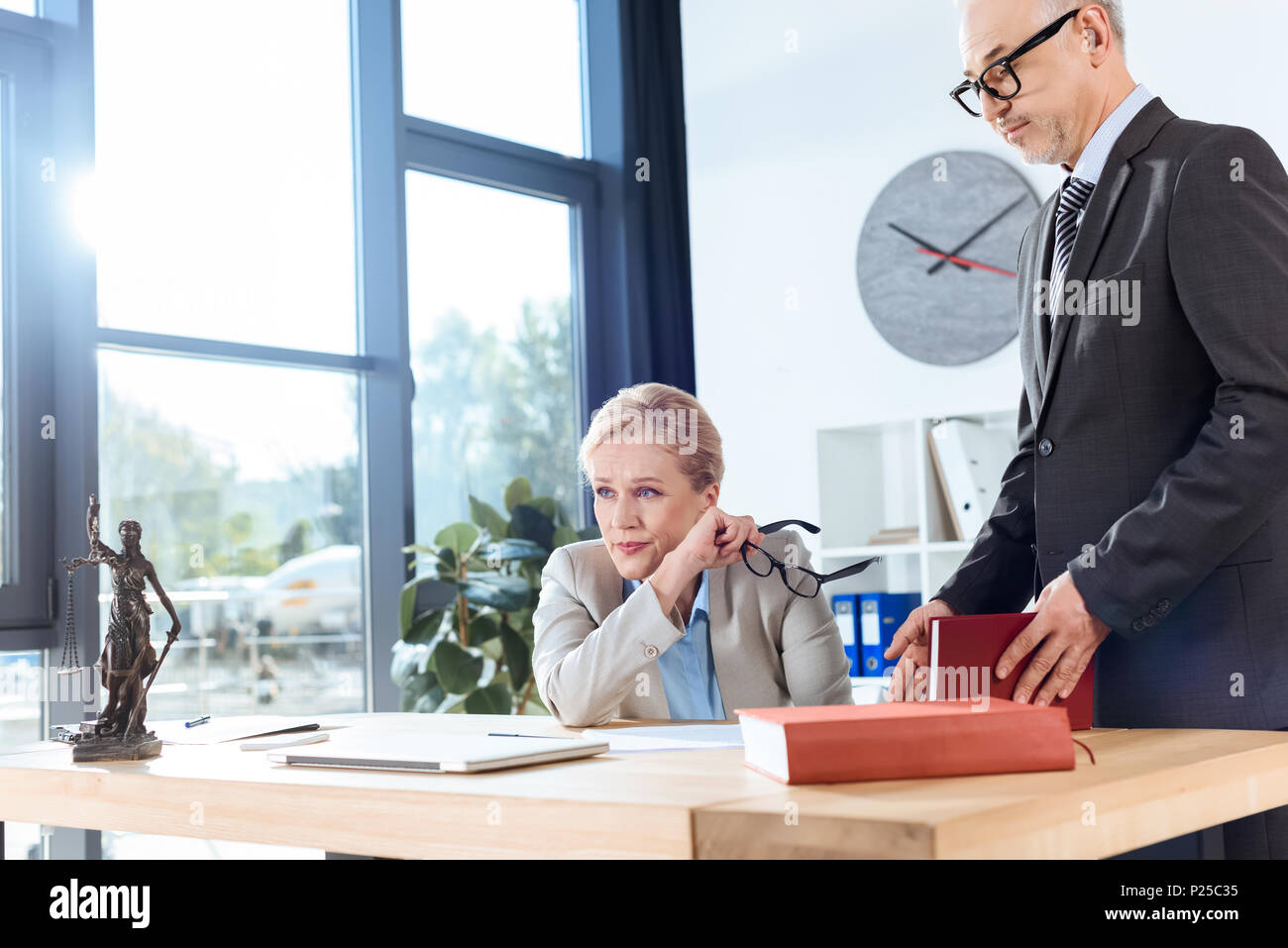 mature overworked colleagues at modern office Stock Photo - Alamy