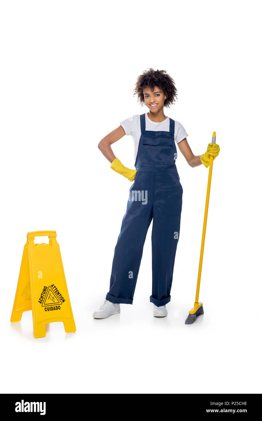 african american female cleaner with broom standing akimbo isolated on ...