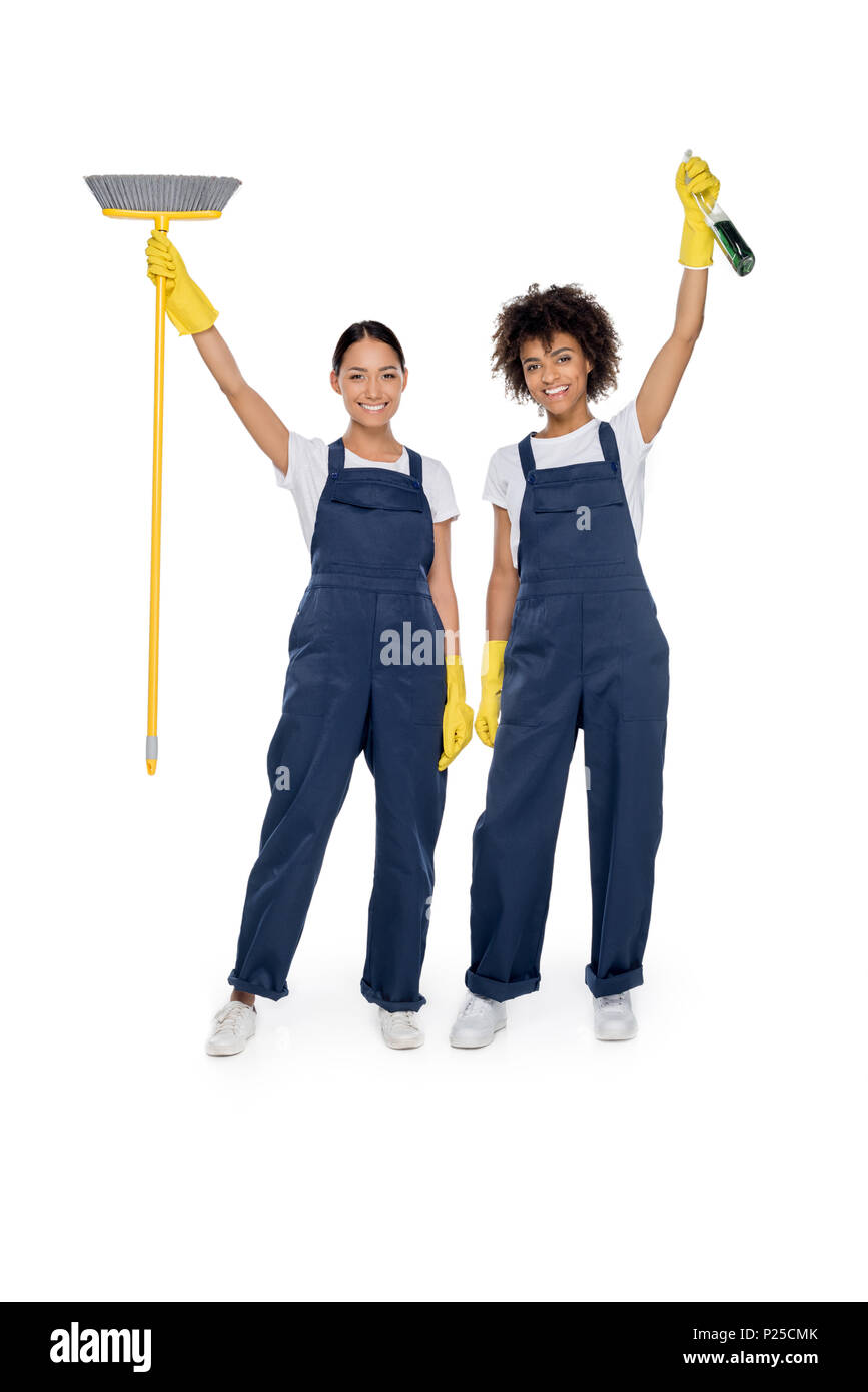 multiethnic smiling cleaners in uniforms with broom and detergent ...