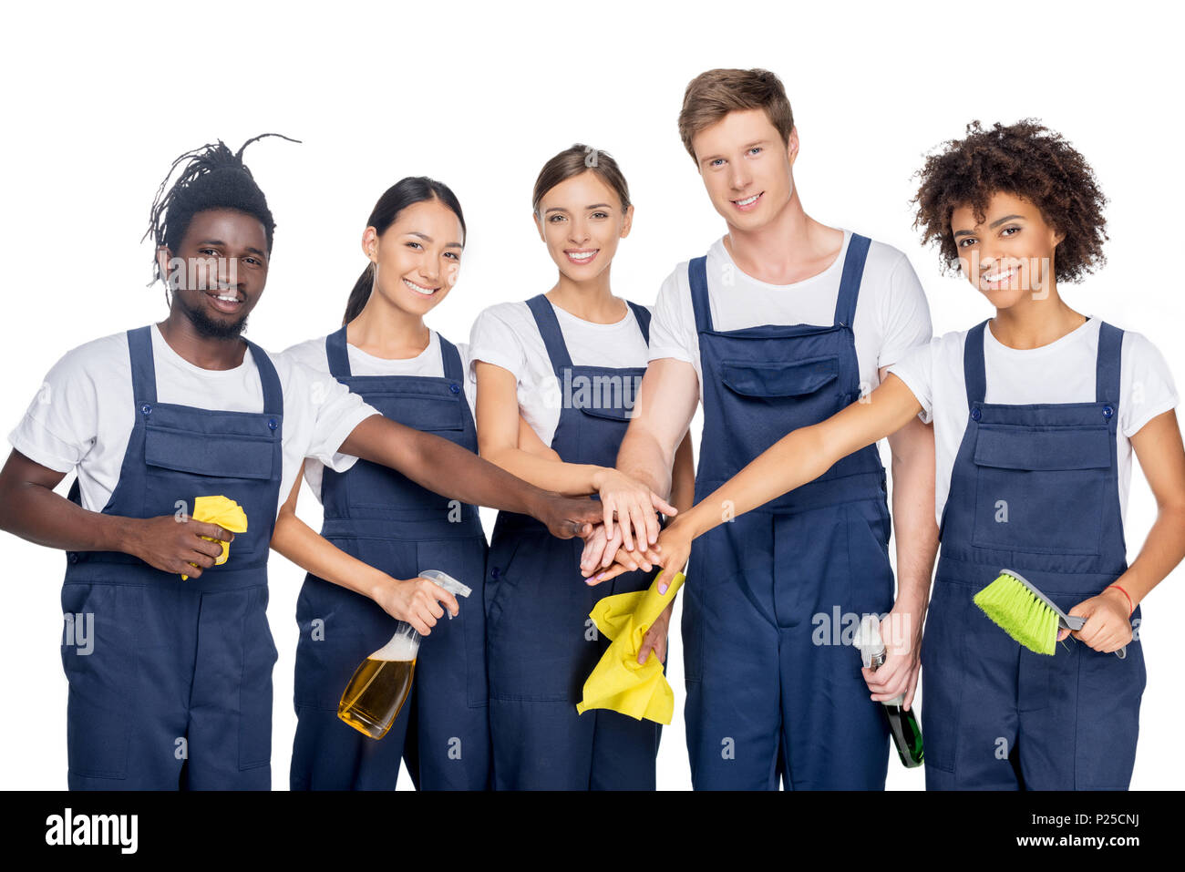 group of young multiethnic cleaners with various cleaning supplies ...