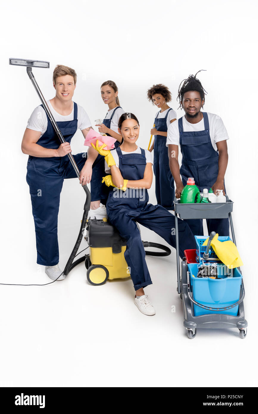 group of young multiethnic cleaners with various cleaning supplies ...