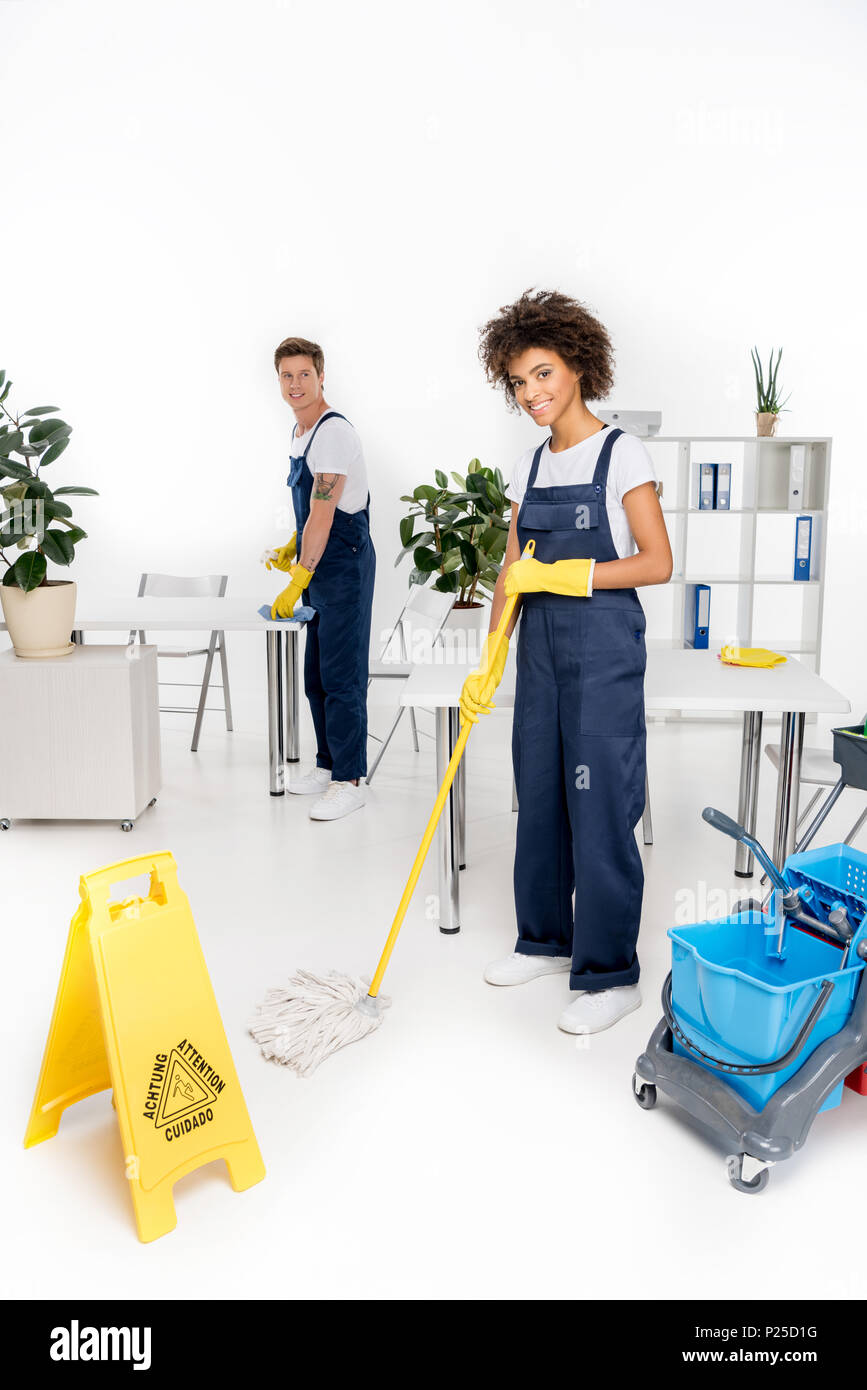 professional young multiethnic male and female cleaners working ...