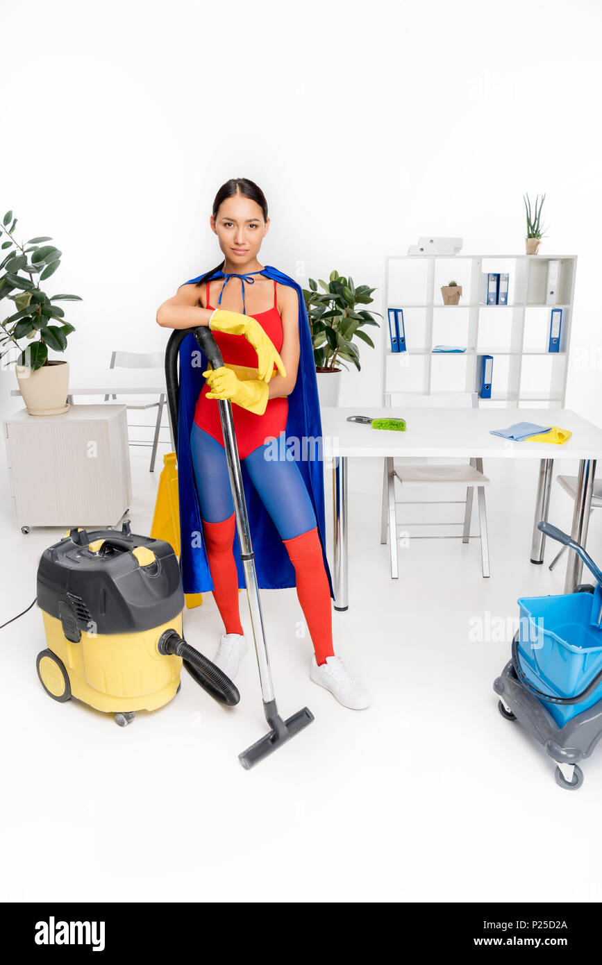 beautiful young asian woman in superhero costume posing with vacuum ...