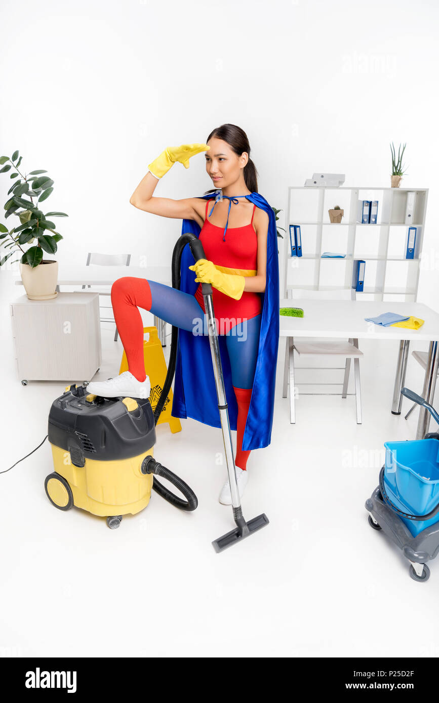 beautiful young asian woman in superhero costume posing with vacuum ...