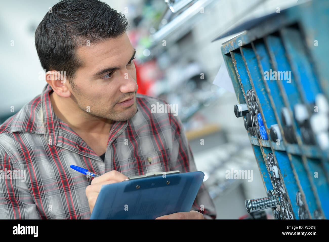 engineer taking notes at control room in factory Stock Photo - Alamy