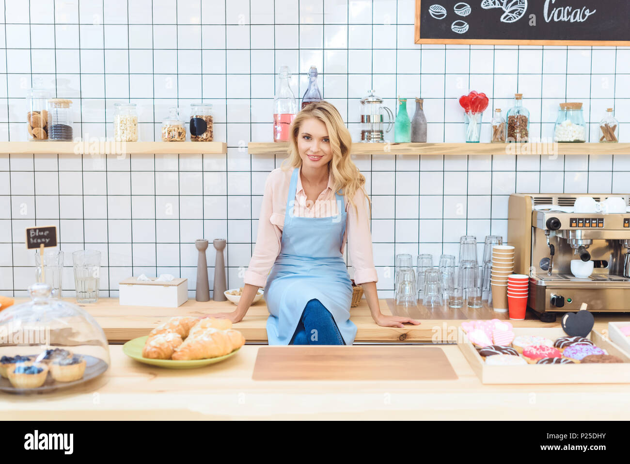 beautiful young waitress smiling at camera in cafe Stock Photo - Alamy