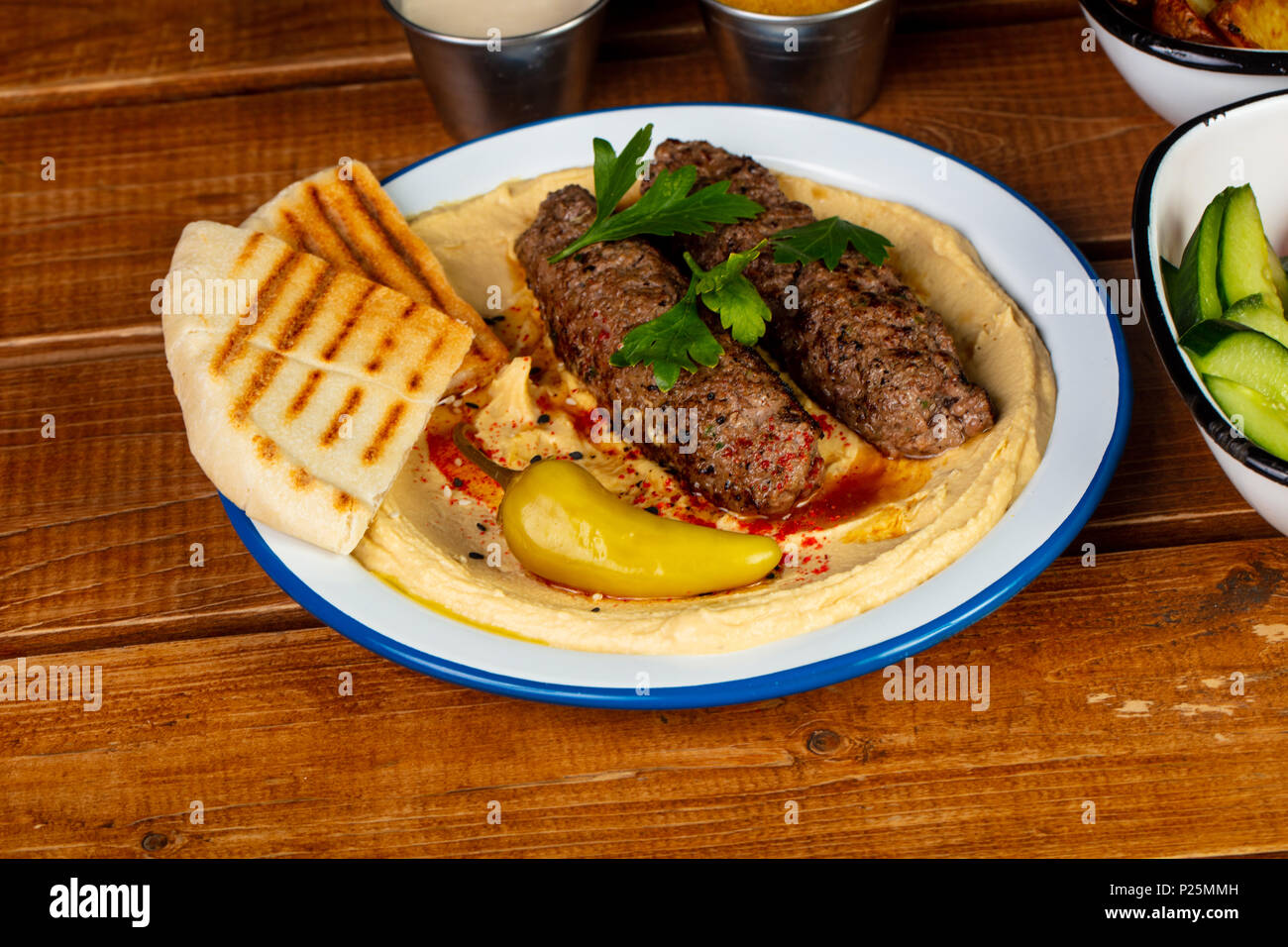 Delicious hummus with kebab with pepper and bread Stock Photo - Alamy