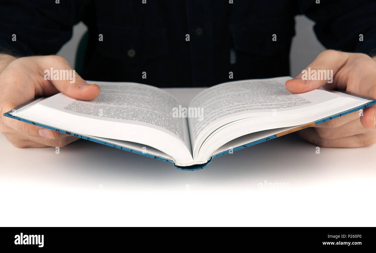 Book in mans hands hi-res stock photography and images - Alamy