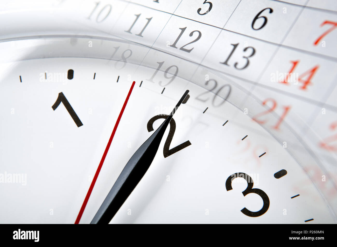wall calendar with the number of days and clock closeup Stock Photo - Alamy