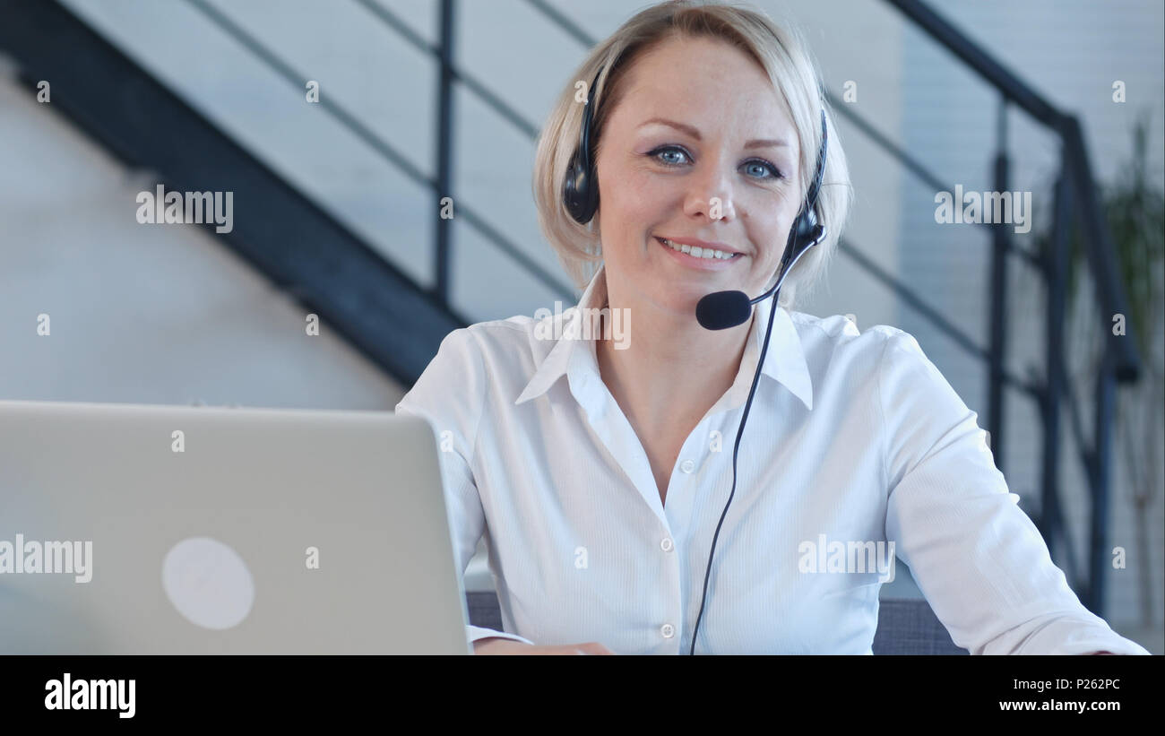 Beautiful business customer service woman smiling talking to a camera ...