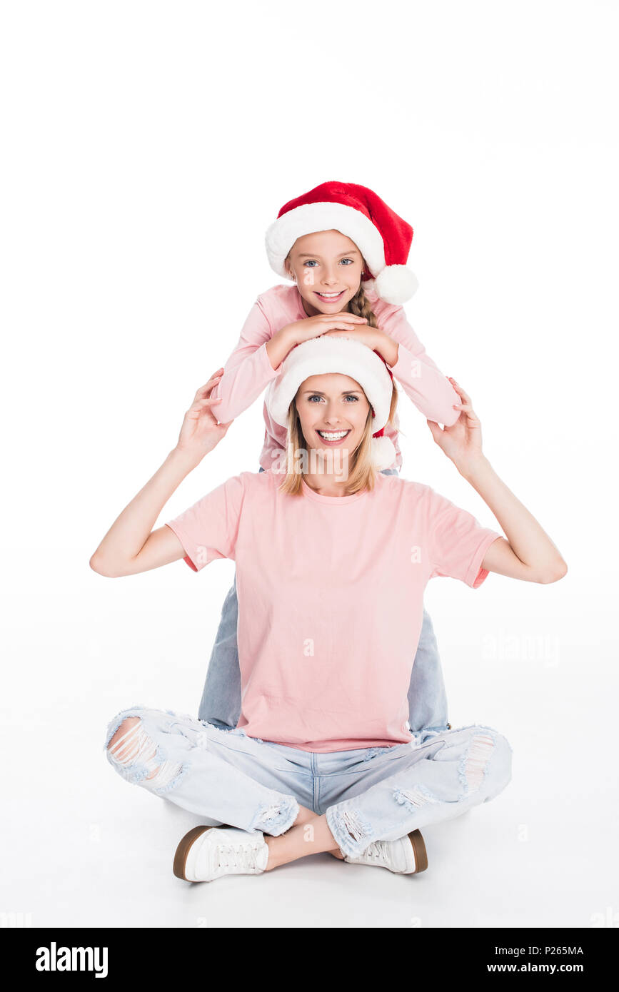 happy mother and daughter wearing santa hats on christmas, isolated on ...