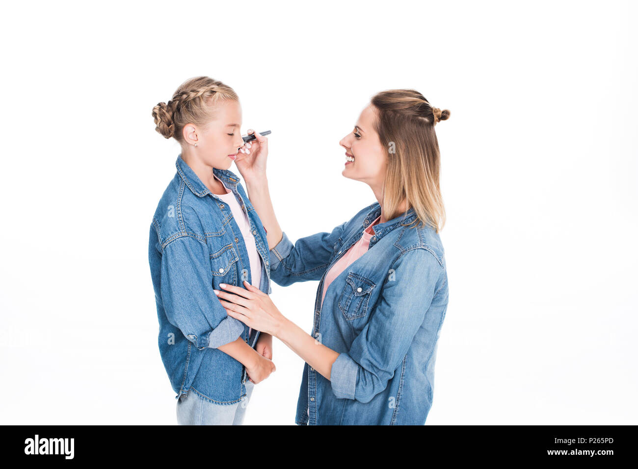 mother and daughter applying makeup together, isolated on white Stock ...