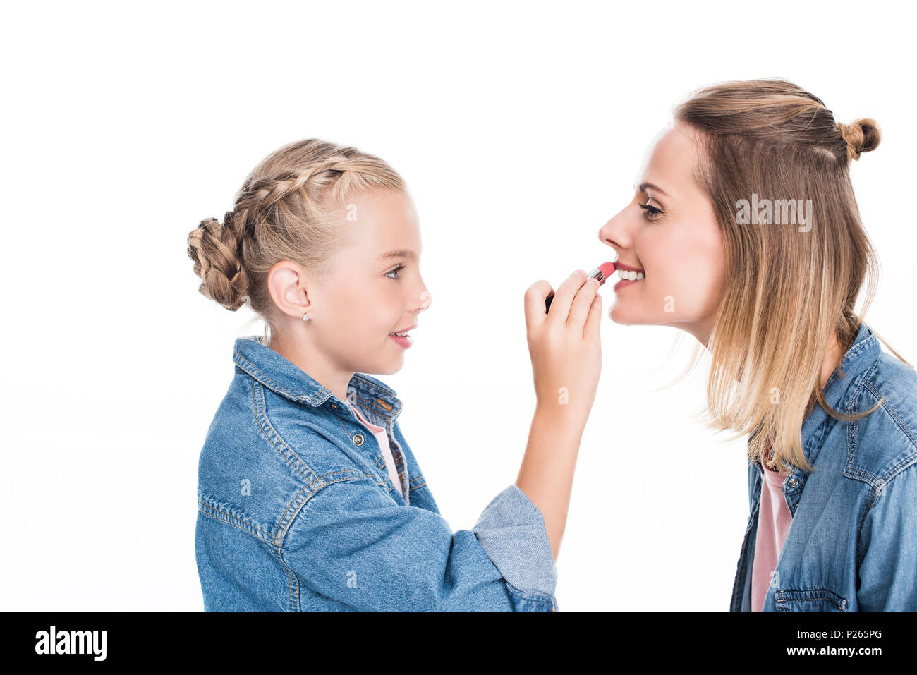 Mother applying makeup to her daughter hi-res stock photography and ...