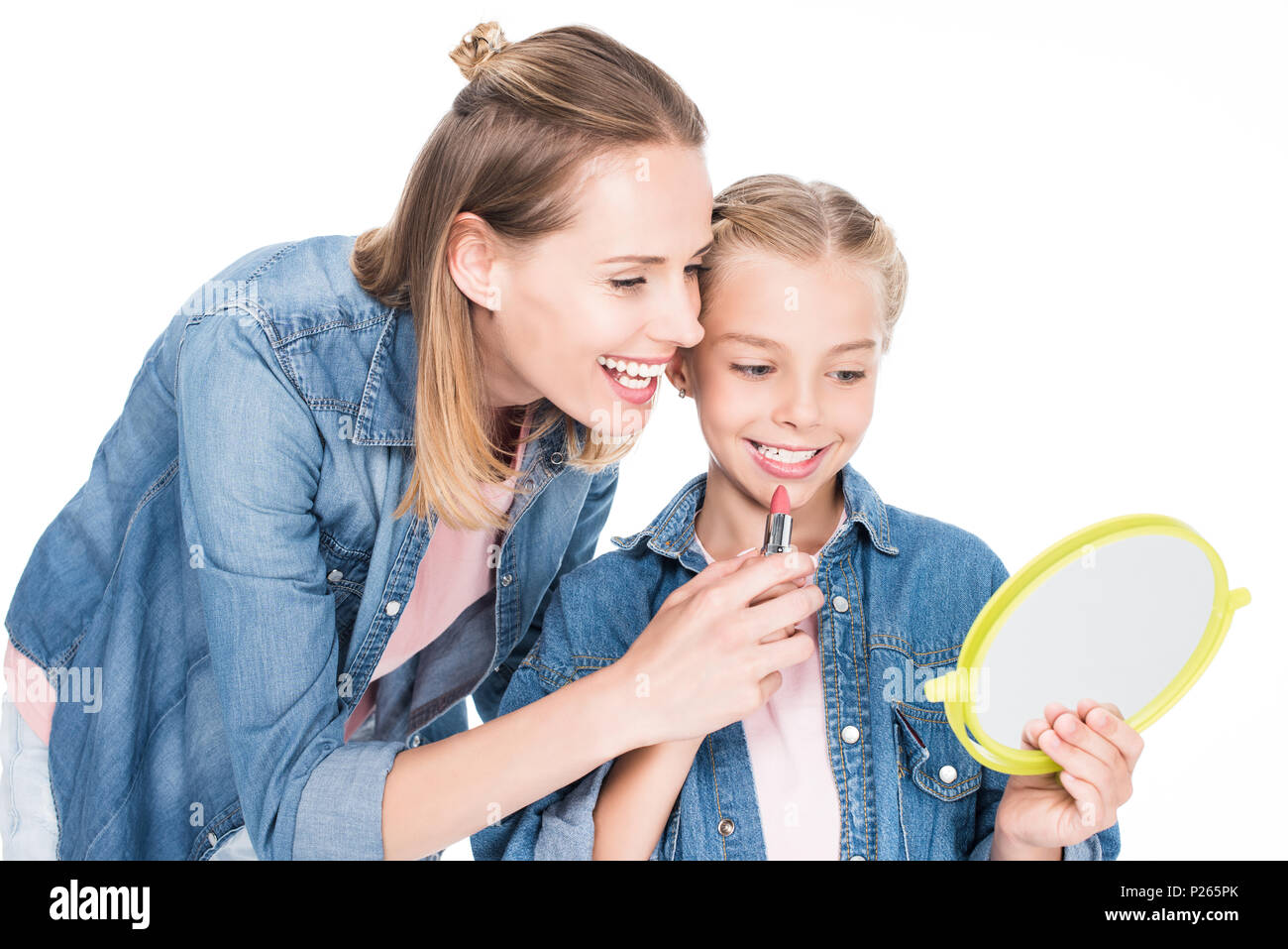 mother and daughter applying makeup together, isolated on white Stock ...