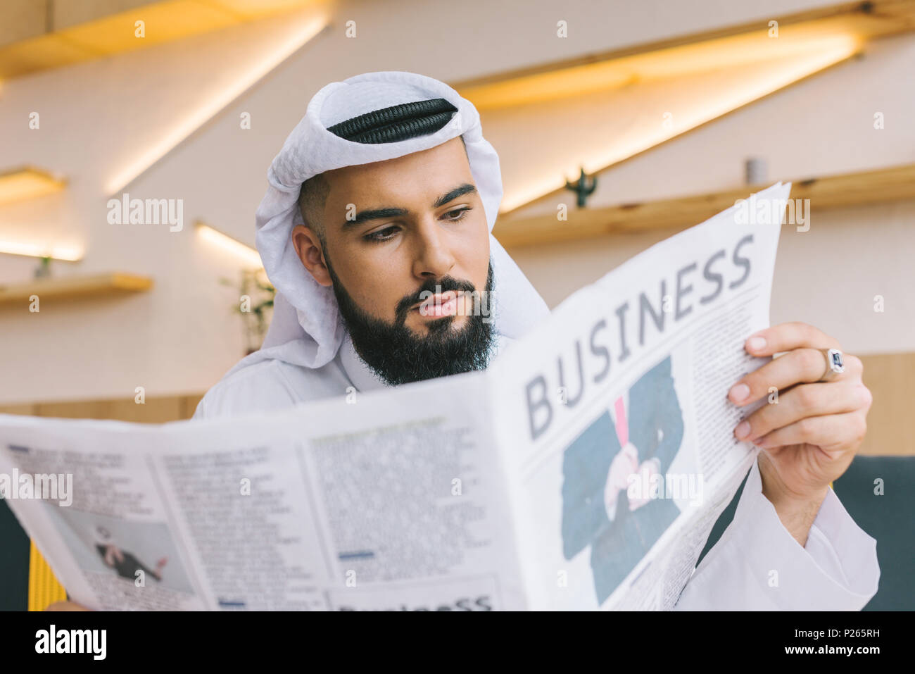 close-up shot of serious muslim businessman reading newspaper Stock ...