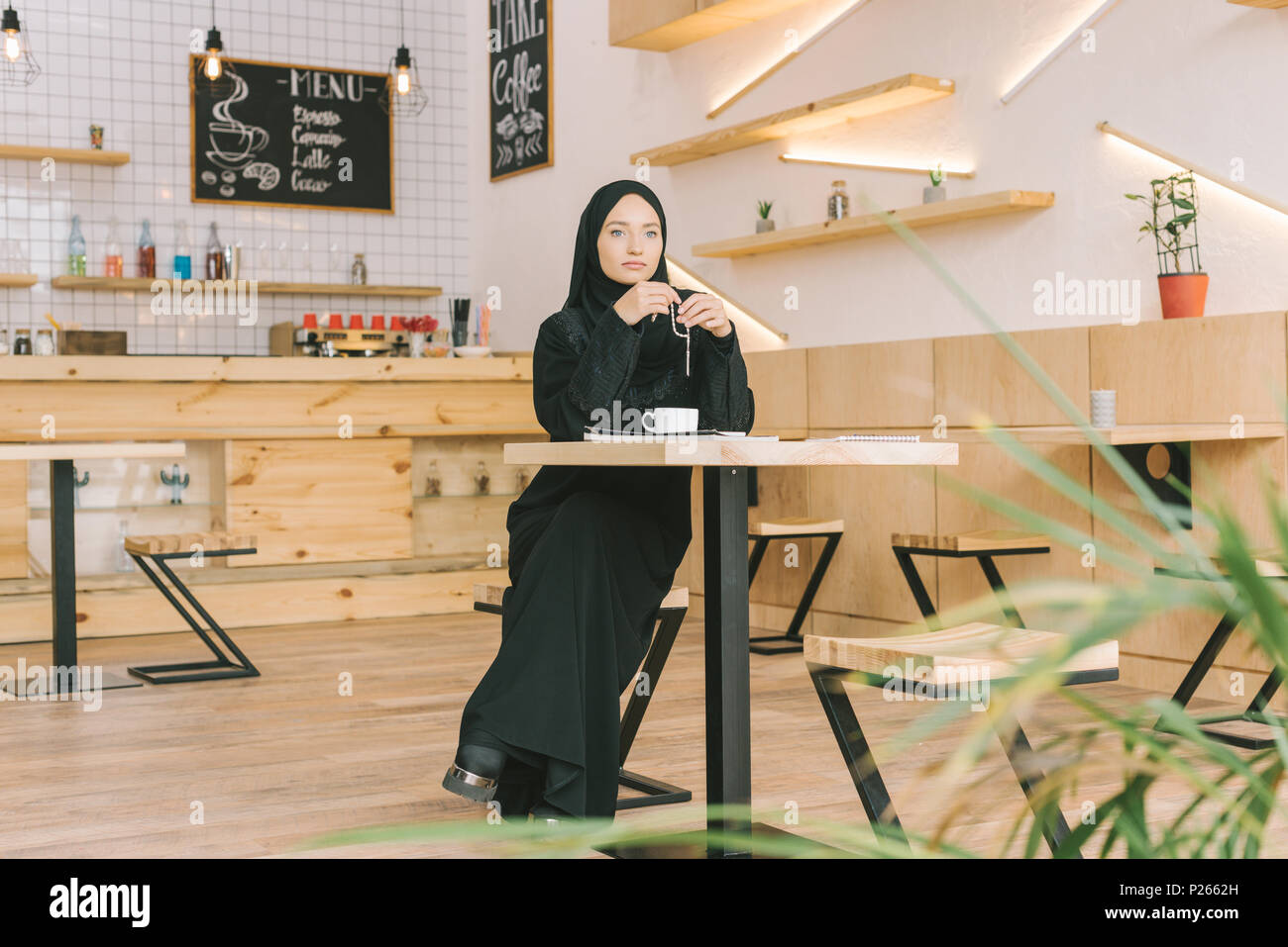 beautiful muslim woman with prayer beads sitting in cafe Stock Photo ...