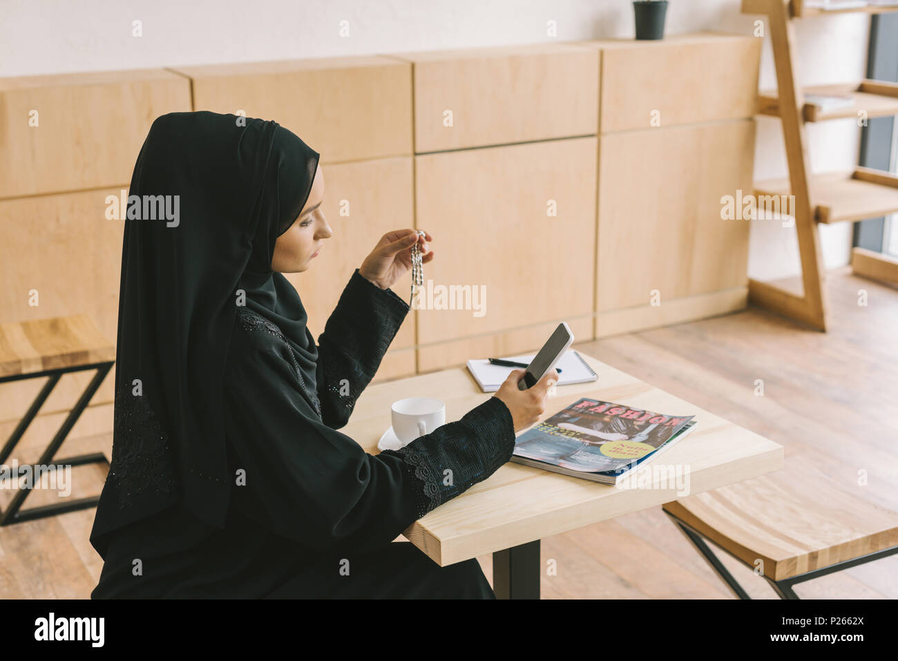 Muslim woman in cafe using hi-res stock photography and images - Alamy