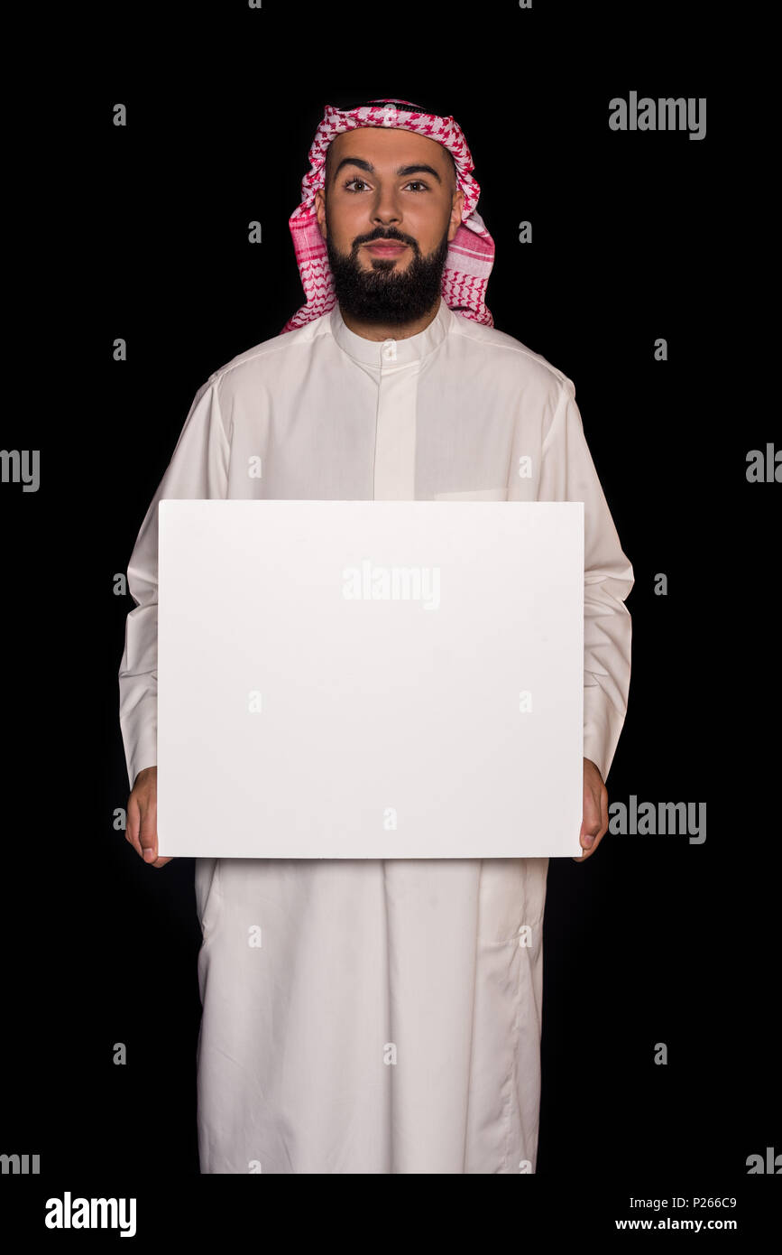 happy handsome muslim man holding blank board isolated on black Stock ...