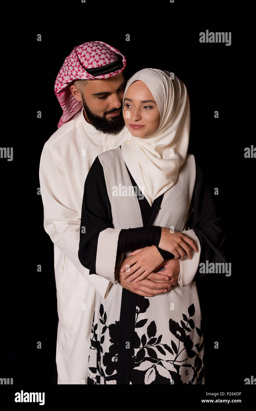 beautiful embracing muslim couple isolated on black Stock Photo - Alamy