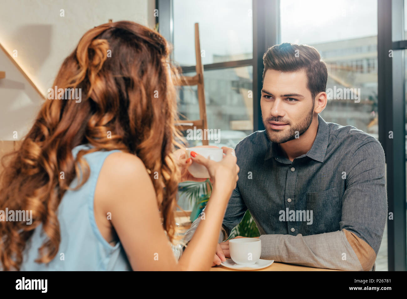 partial view of couple drinking coffee together in cafe Stock Photo - Alamy