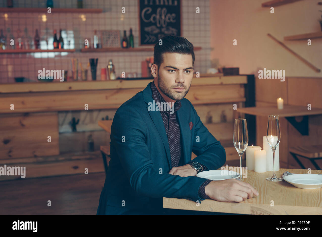 Man sitting alone at dinner table hi-res stock photography and images ...